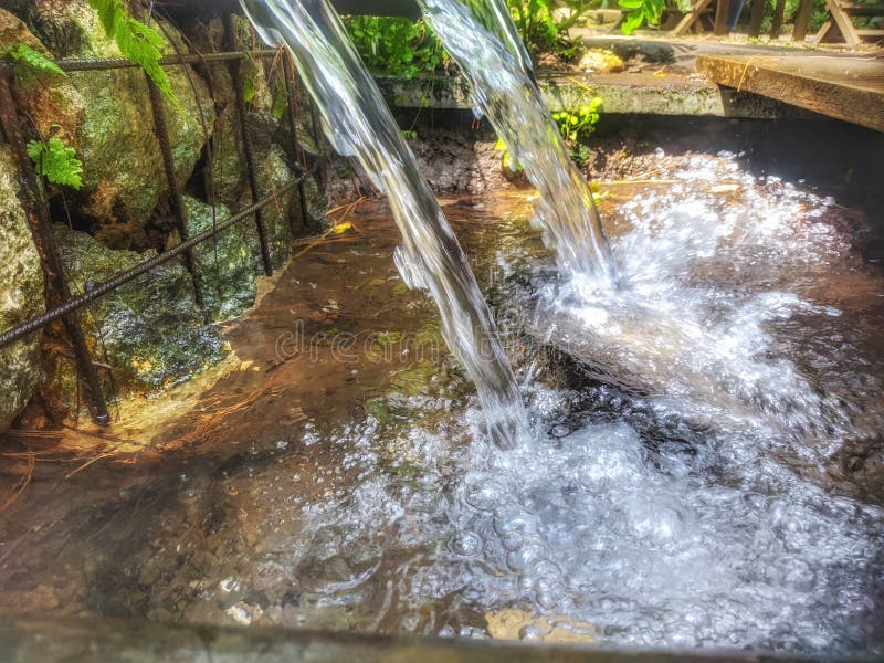 The Water Source from the Hill Flows through the Pipe Stock Photo ...