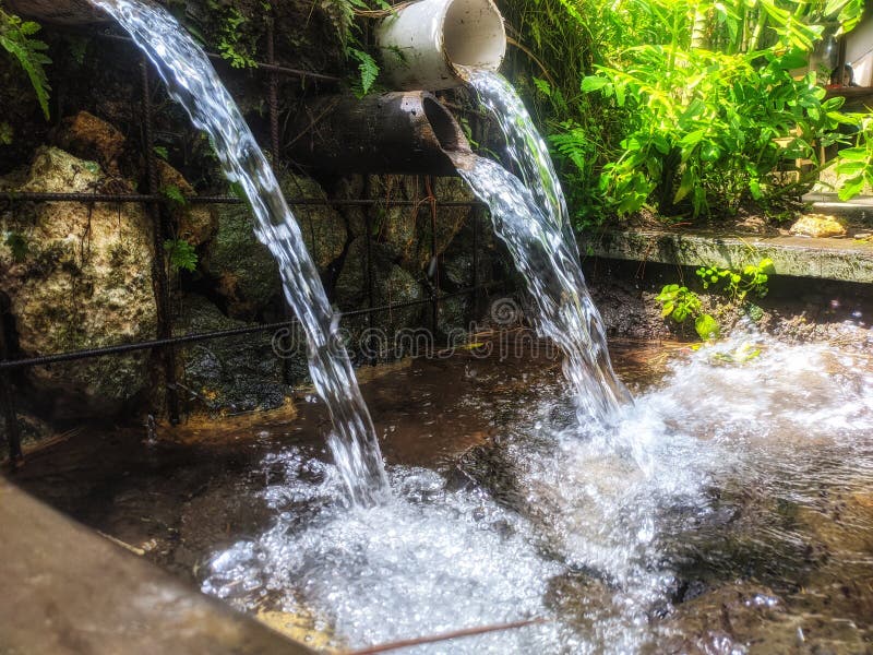 The Water Source from the Hill Flows through the Pipe Stock Photo ...