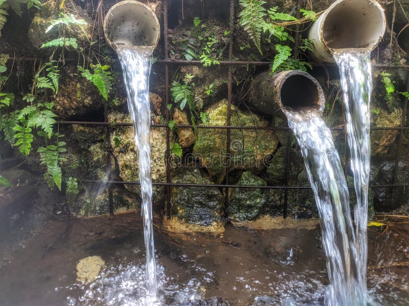 The Water Source from the Hill Flows through the Pipe Stock Photo ...