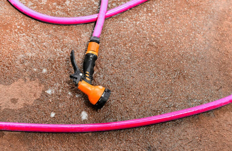 Water Spay Gun and Pipe on Wet Ground, Washing Tool Stock Photo - Image ...