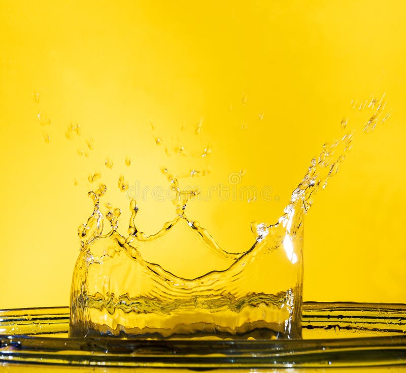 Water Splash on Bright Glowing Yellow Background Stock Photo - Image of ...