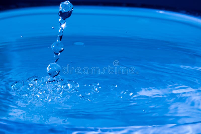 Water Splash in Dark Blue Color with a Drop of Water Flying from Stock ...