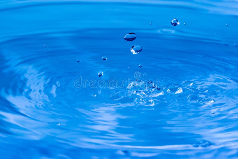 Water Splash in Dark Blue Color with a Drop of Water Flying from Stock ...
