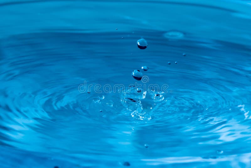 Water Splash in Dark Blue Color with a Drop of Water Flying from Stock ...