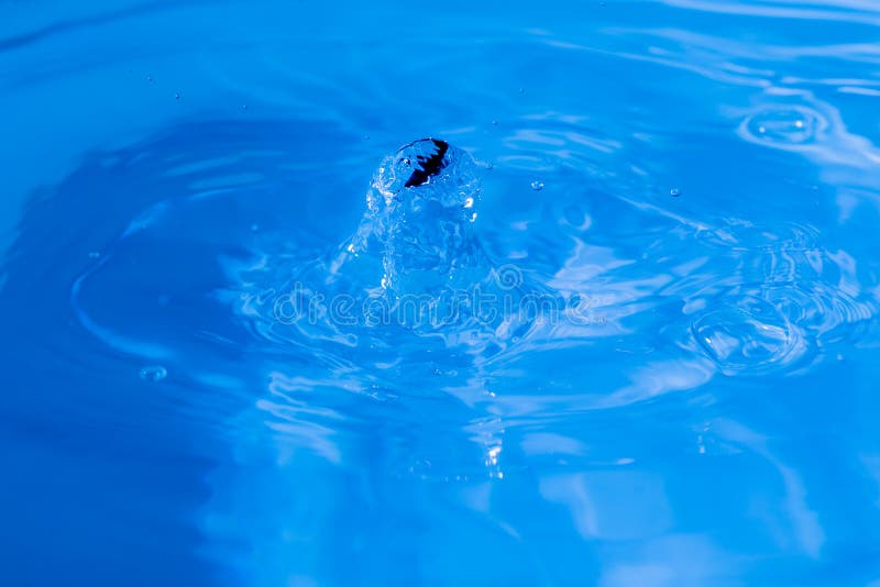 Water Splash in Dark Blue Color with a Drop of Water Flying from Stock ...