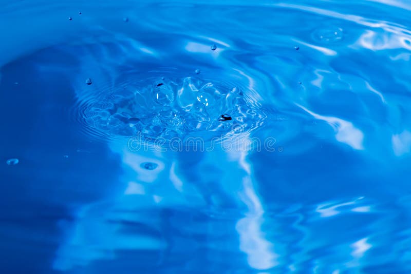 Water Splash in Dark Blue Color with a Drop of Water Flying from Stock ...
