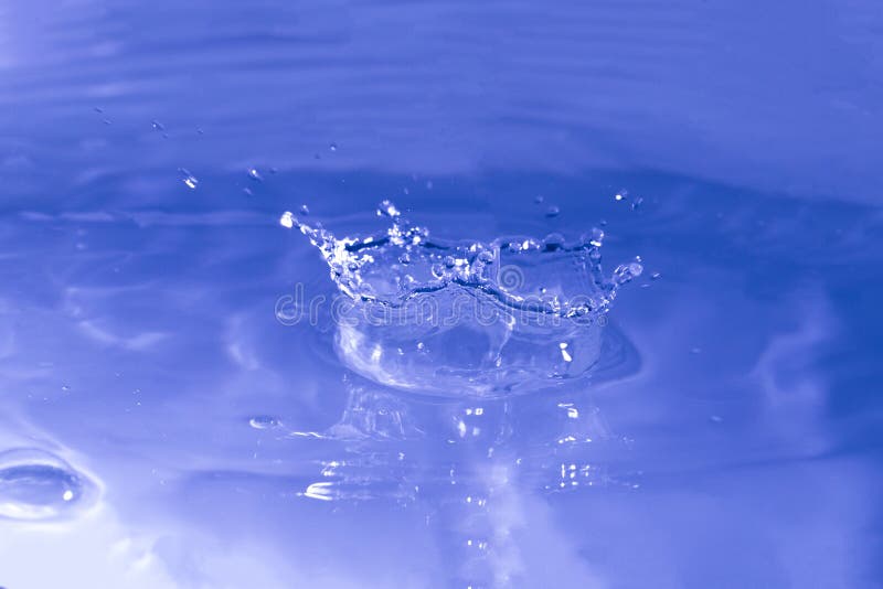 Water Splash in Dark Blue Color with a Drop of Water Flying from Stock ...
