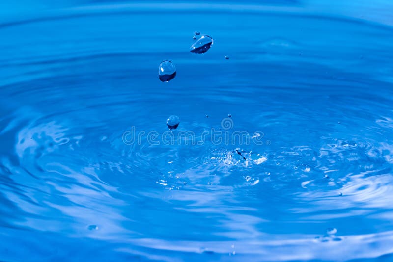 Water Splash in Dark Blue Color with a Drop of Water Flying from Stock ...