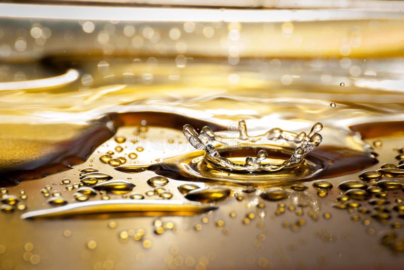 Water splash on gold plate stock photo. Image of colored - 54151812