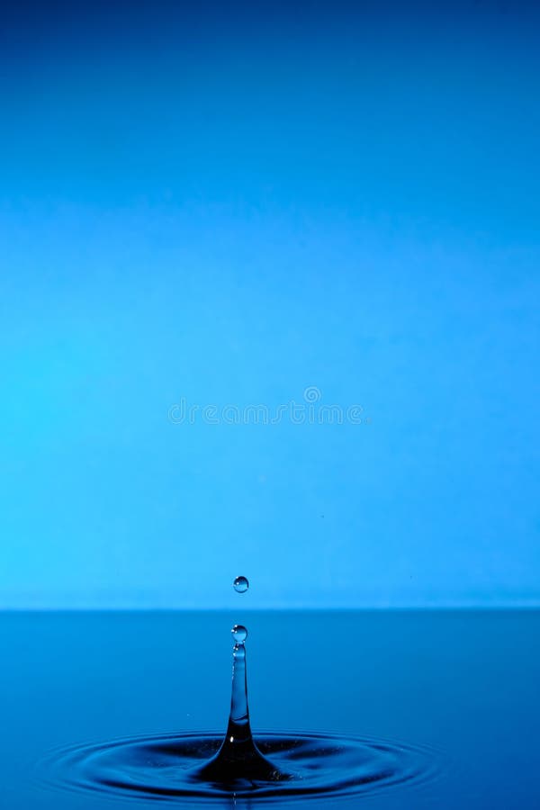Water Splashes after Raindrop Falls.Blue Abstract Background with ... Water Splashes after Raindrop Falls.Blue Abstract Background with ...