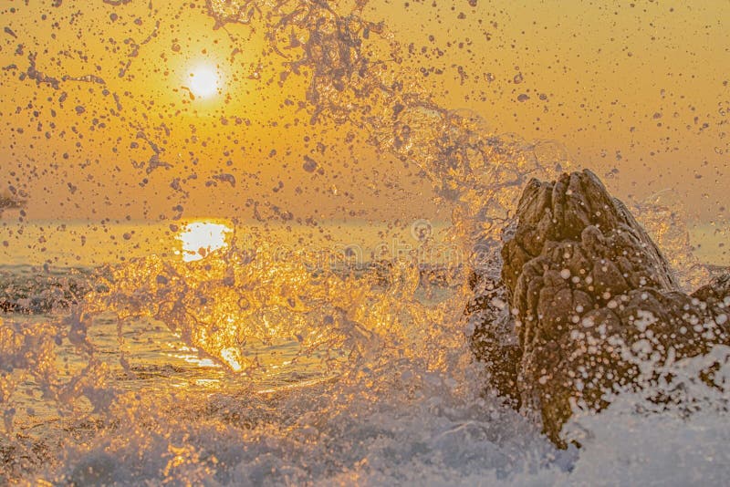Water Splashing on the Rock at Sunset. Stock Photo - Image of rock ...