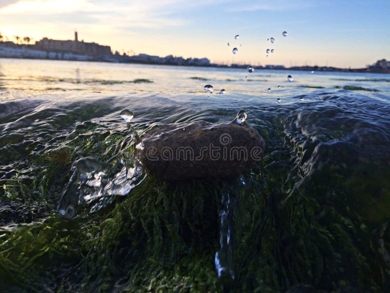 Water splashing a rock stock image. Image of rock, splashing - 53583975