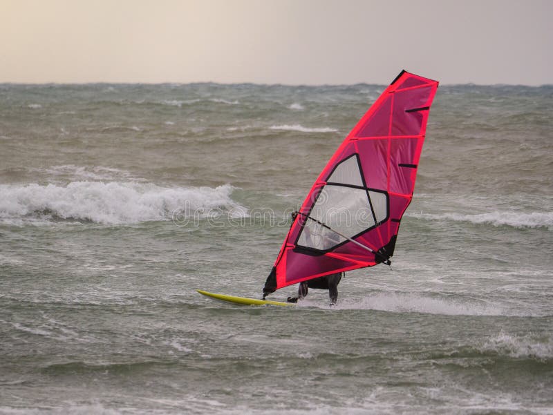 Water Sport Activity - Windsurfer Riding a Wave in Rough Sea on a Windy ...