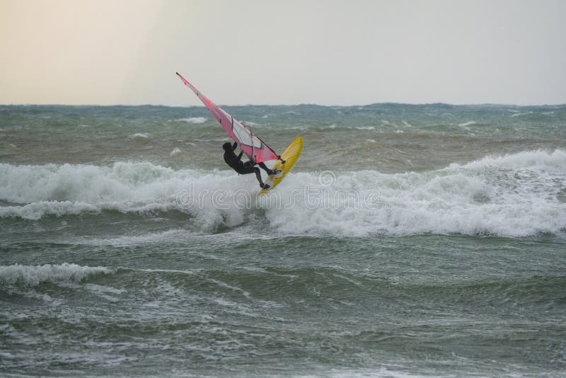 Water Sport Activity - Windsurfer Riding a Wave in Rough Sea on a Windy ...