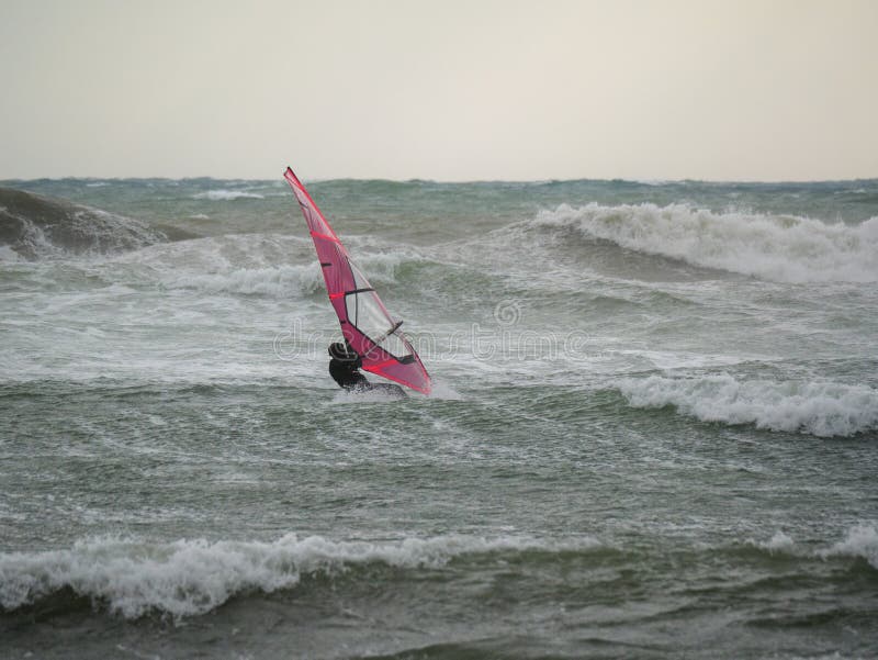 Water Sport Activity - Windsurfer Riding a Wave in Rough Sea on a Windy ...