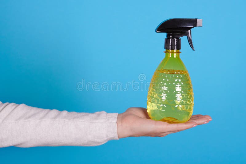 Water spray bottle in hand stock photo. Image of woman - 188766962