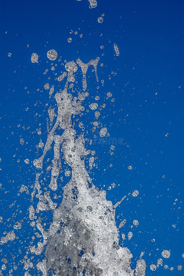 Water Spray from a Fountain on a Clear Blue Sky Stock Photo - Image of ...