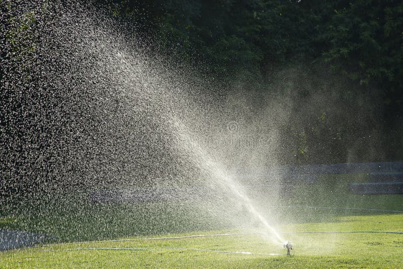 Water spray on green field stock image. Image of equipment - 51288307