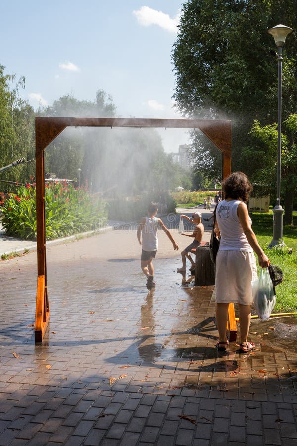 Water spray in the park. editorial stock image. Image of cycling - 97586949