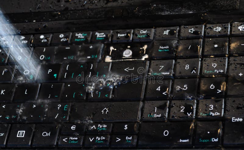 Water Spray Pouring Onto Laptop Computer Keyboard with Bilingual Keys ...