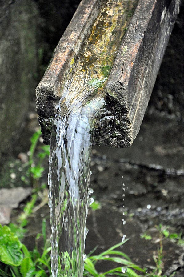 Water spring and wood pipe stock photo. Image of colored - 200430452