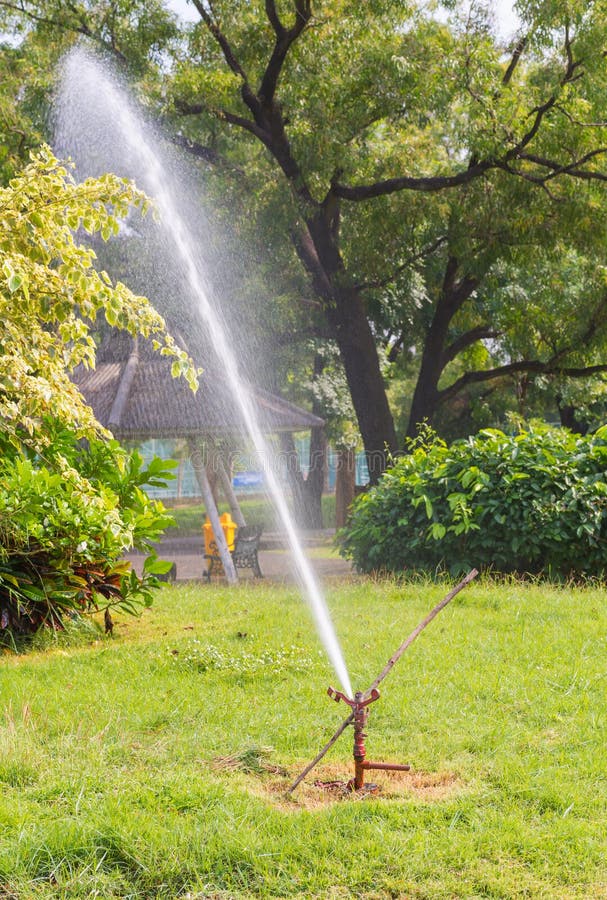 Water Sprinkler in Public Park Stock Photo - Image of automated ...