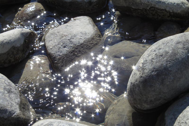 Water stars on rocks. stock photo. Image of light, rocks - 65928594