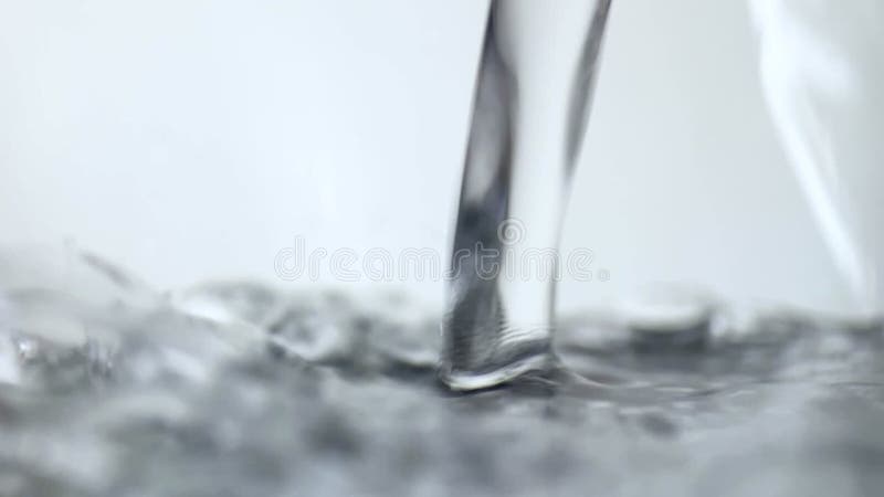 Water Stream in Slow Motion Falls on Smooth Clean Surface, Creating Air ...