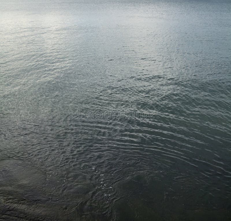Water surface with ripples stock image. Image of reflection - 258547311