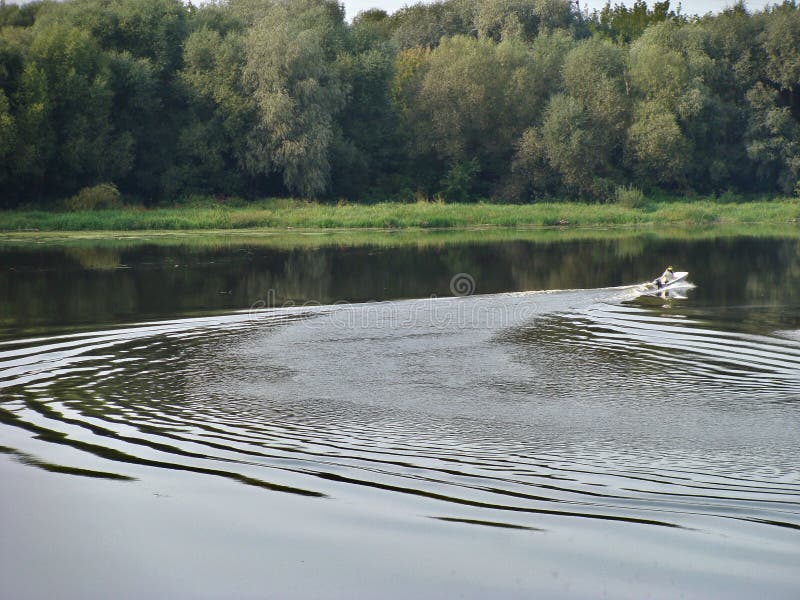 The Water Surface of the River with a Boat Stock Photo - Image of lake ...
