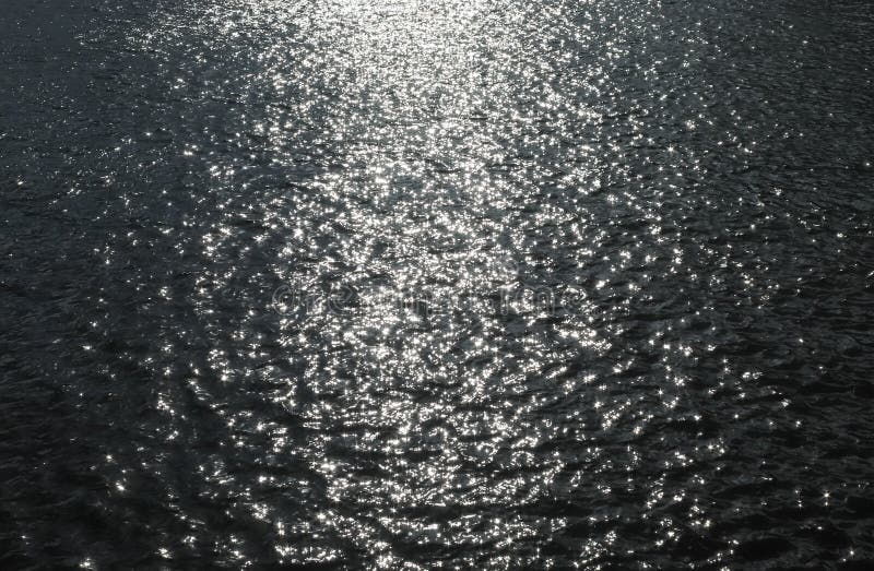 Water Surface with Waves and Ripples and the Sunlight Reflecting at the ...
