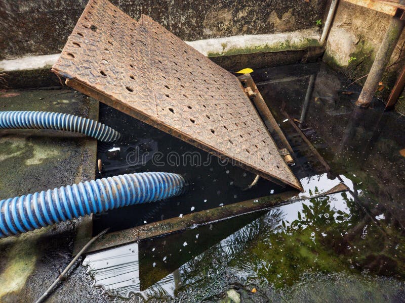 A Water Tank Filled with Dirty Water and Overflowing Stock Image ...