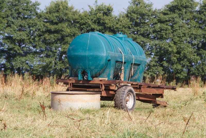 Water Tank Trailer for Cattle in a Field Stock Photo - Image of field ...