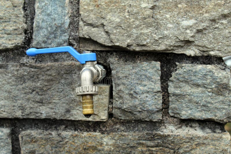 Water Tap on a Natural Rock Wall Stock Photo - Image of metal, drinking ...