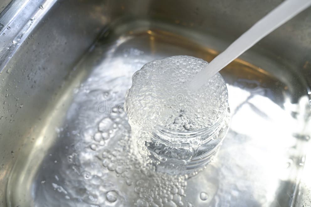 Water from Tap into Plastic Container and Overflow To the Sink Stock ...