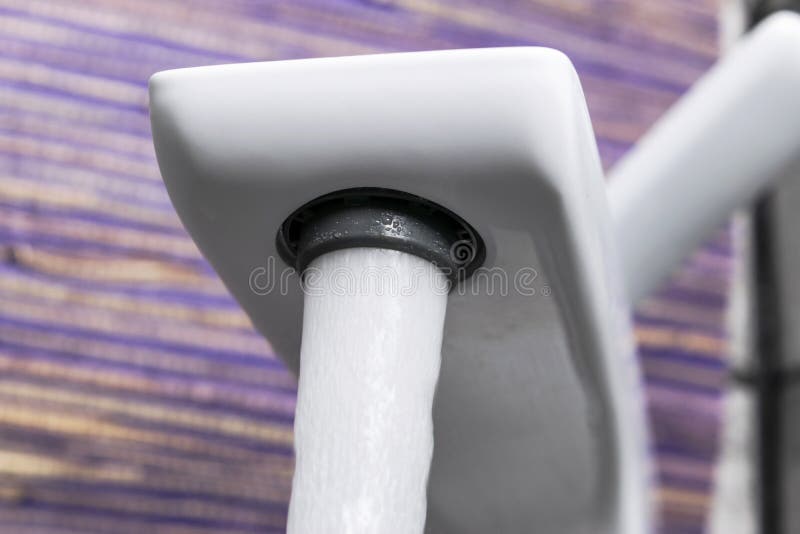 The Water Tap With Water Stream And Drops Faucet For The Bathroom And