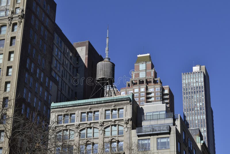 Water Tower on Top of a Building Stock Image - Image of tank, side ...
