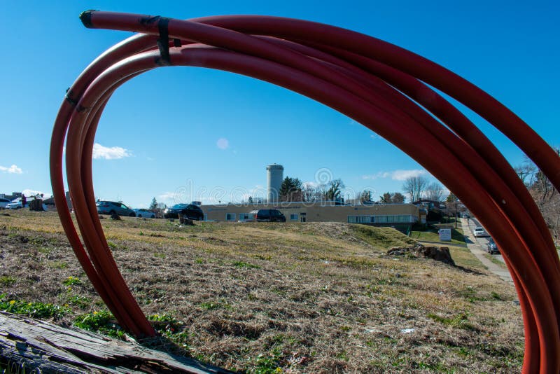 Looking through a Red Looped Pipe Stock Photo - Image of copy, clouds ...