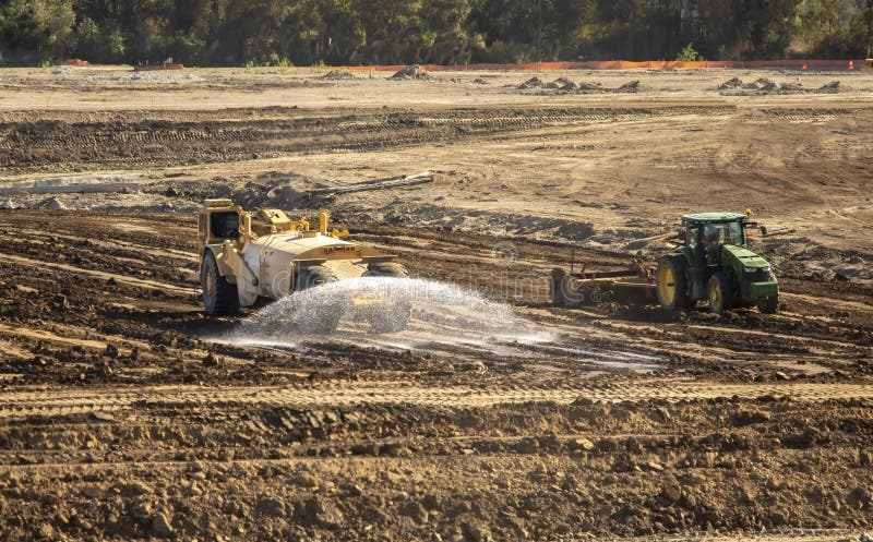 Water Truck Spraying Water on a Construction Site To Keep Dust from ...
