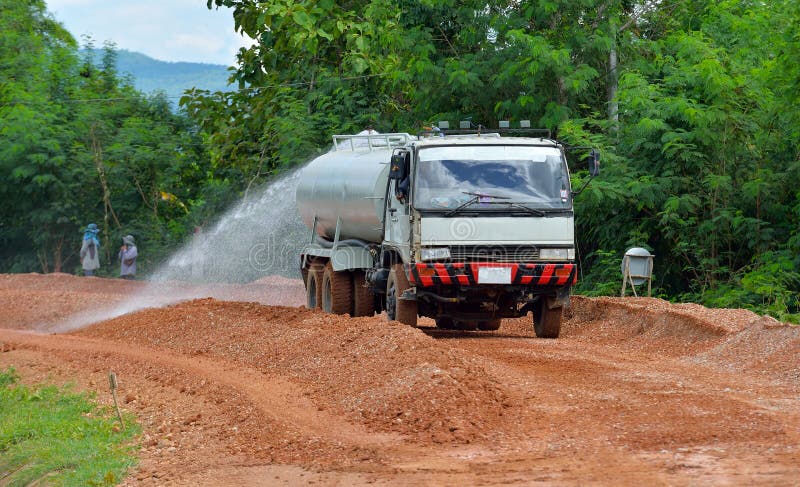 Water Truck Sprays Water on New Road Construction Project. Stock Image ...