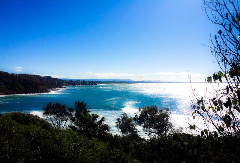 Distant Beach Seen Across Green Hills Stock Photo - Image of sandy ...