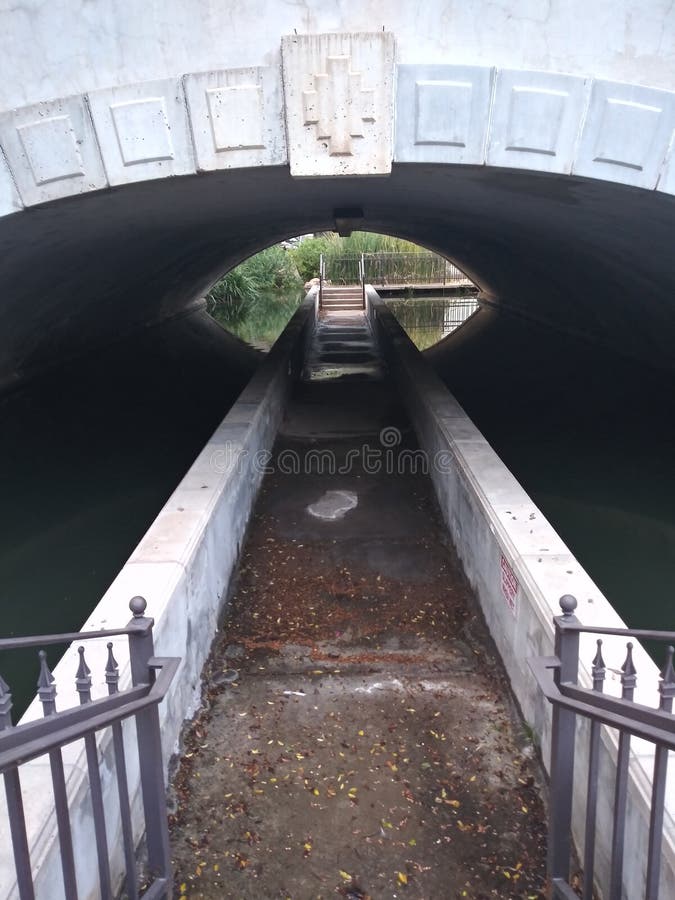 Water walkway under bridge stock photo. Image of bridge - 166306410