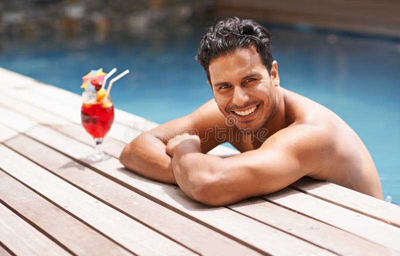 The Water is Warm and the Drinks are Cold. a Handsome Young Man Sitting ...