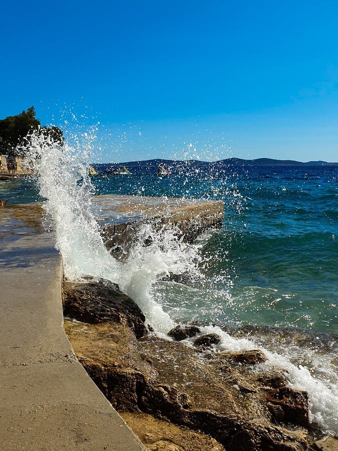 Water Wave Hitting the Concrete Shore. Water Splash Stock Image - Image ...