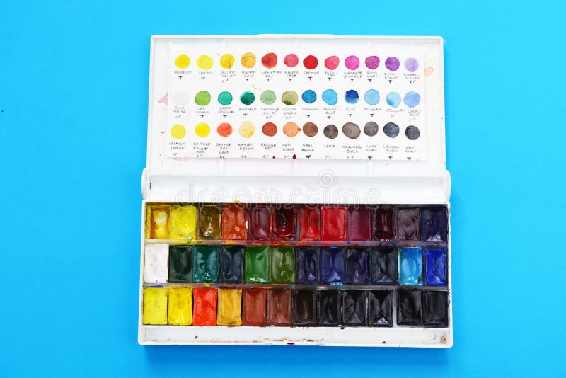 Watercolor Paint in a Box on Blue Background Stock Photo - Image of ...