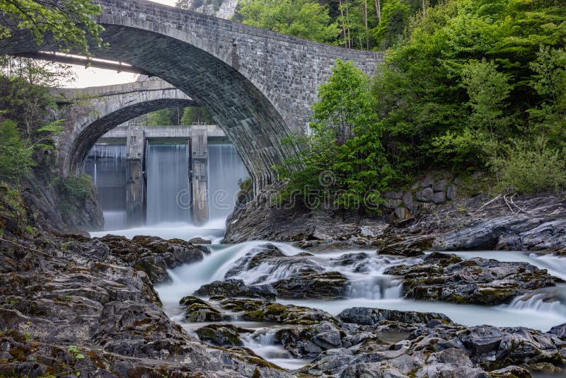 Waterfall Behind an Old Bridge Stock Photo - Image of tranquil, natural ...