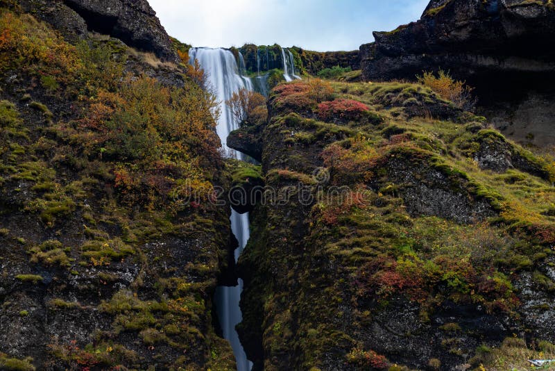 Waterfall behind rocks stock image. Image of fall, water - 165938369