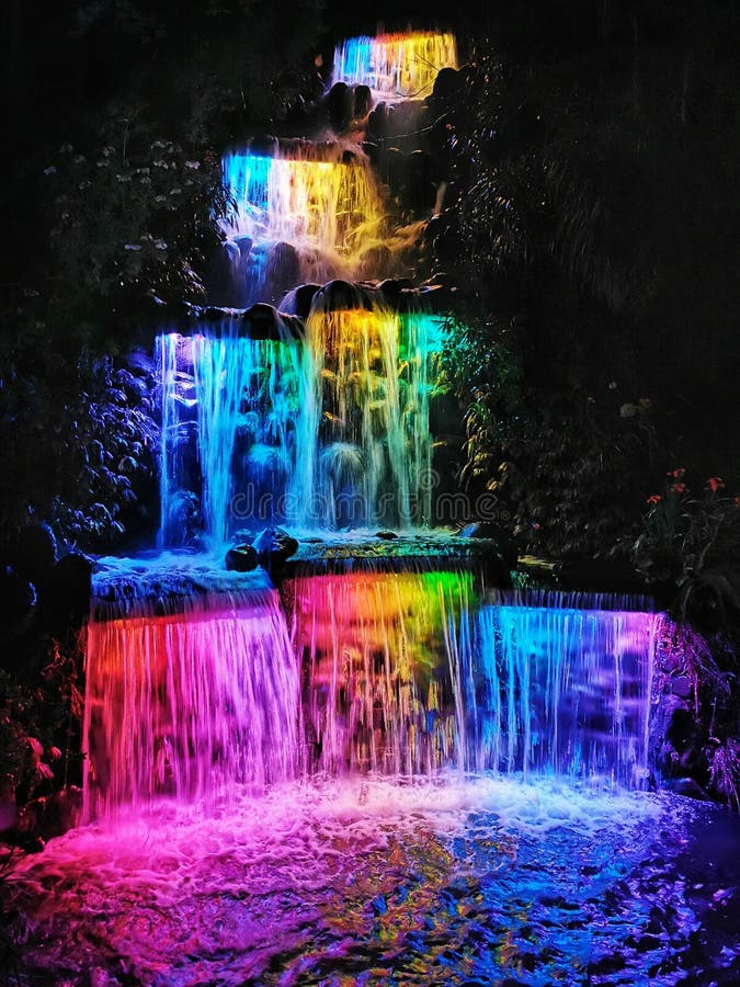 A Waterfall Cascade Lit with Bright Colours at Night Editorial ...