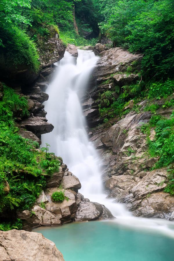 A Mountain Waterfall Flows Over the Rocks. Deep Rainforest Waterfall ...