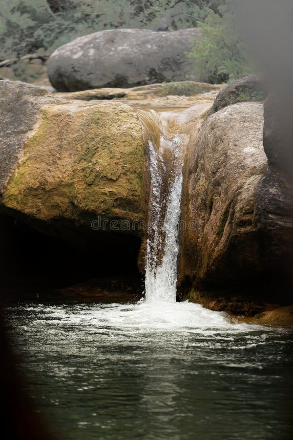 Waterfall Cascading Down a Rocky Cliff Face Stock Photo - Image of ...
